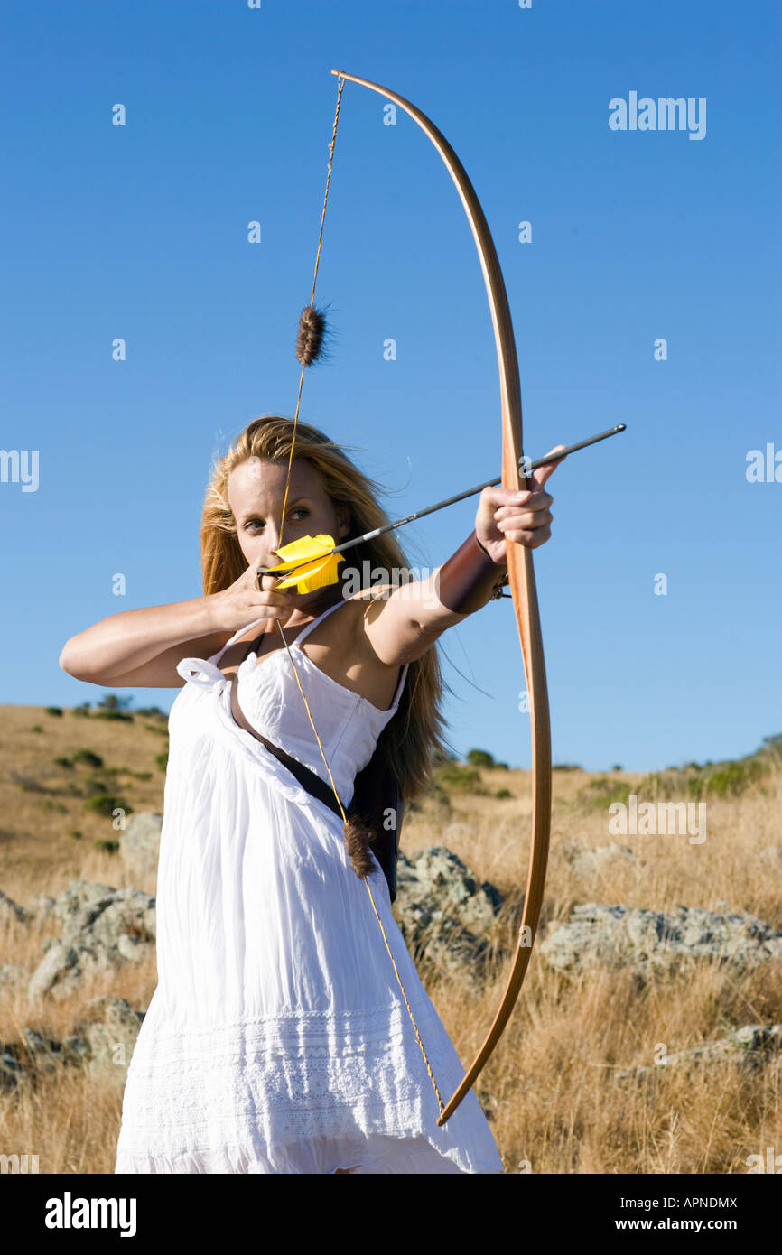 Young woman arrow shooting Stock Photo - Alamy