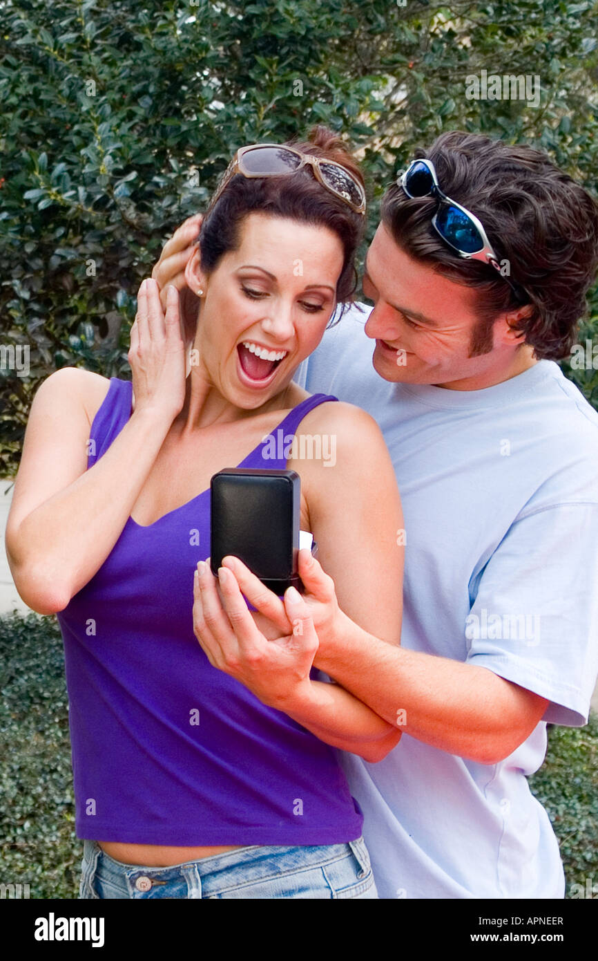 Couple in thier 30s getting a surprise present Stock Photo - Alamy