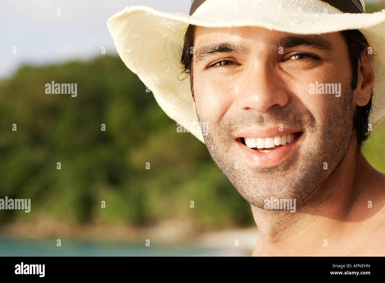 Young man wearing straw hat Stock Photo - Alamy