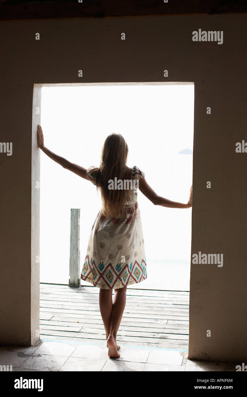 Woman looking out of doorway hi-res stock photography and images - Alamy