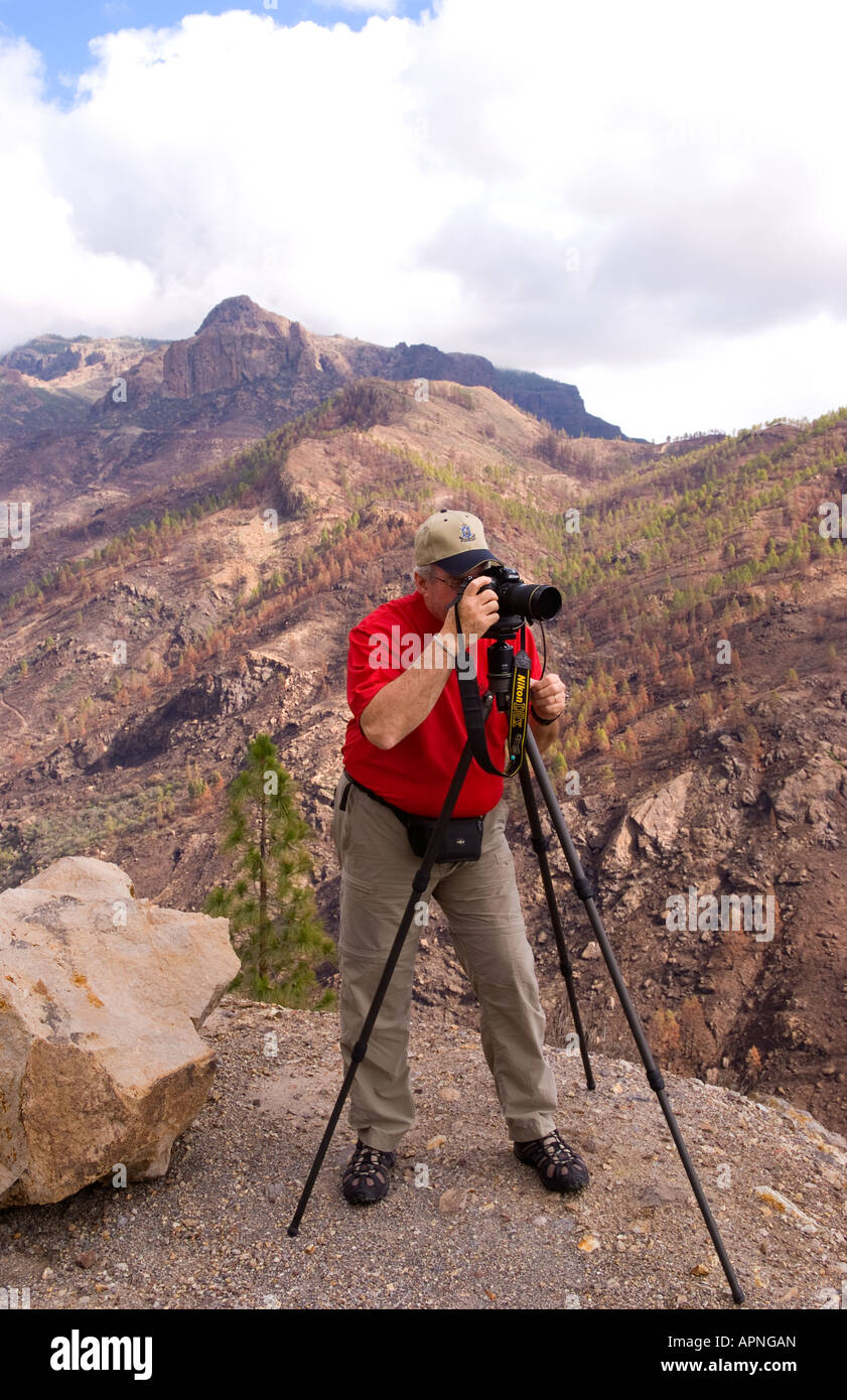 Photographer with tripod taking pictures of remote cliffs of Gran ...