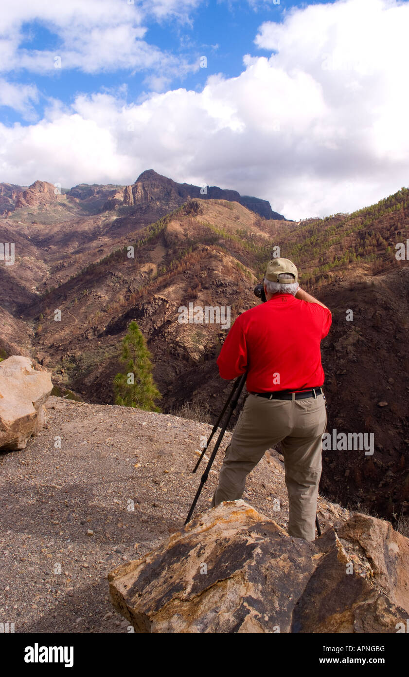 Photographer with tripod taking pictures of remote cliffs of Gran ...