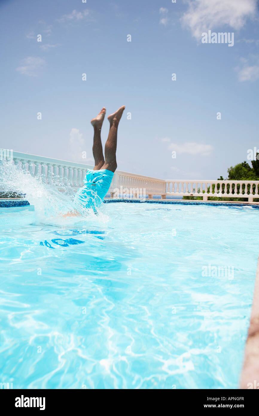 Mid adult man diving into swimming pool Stock Photo - Alamy