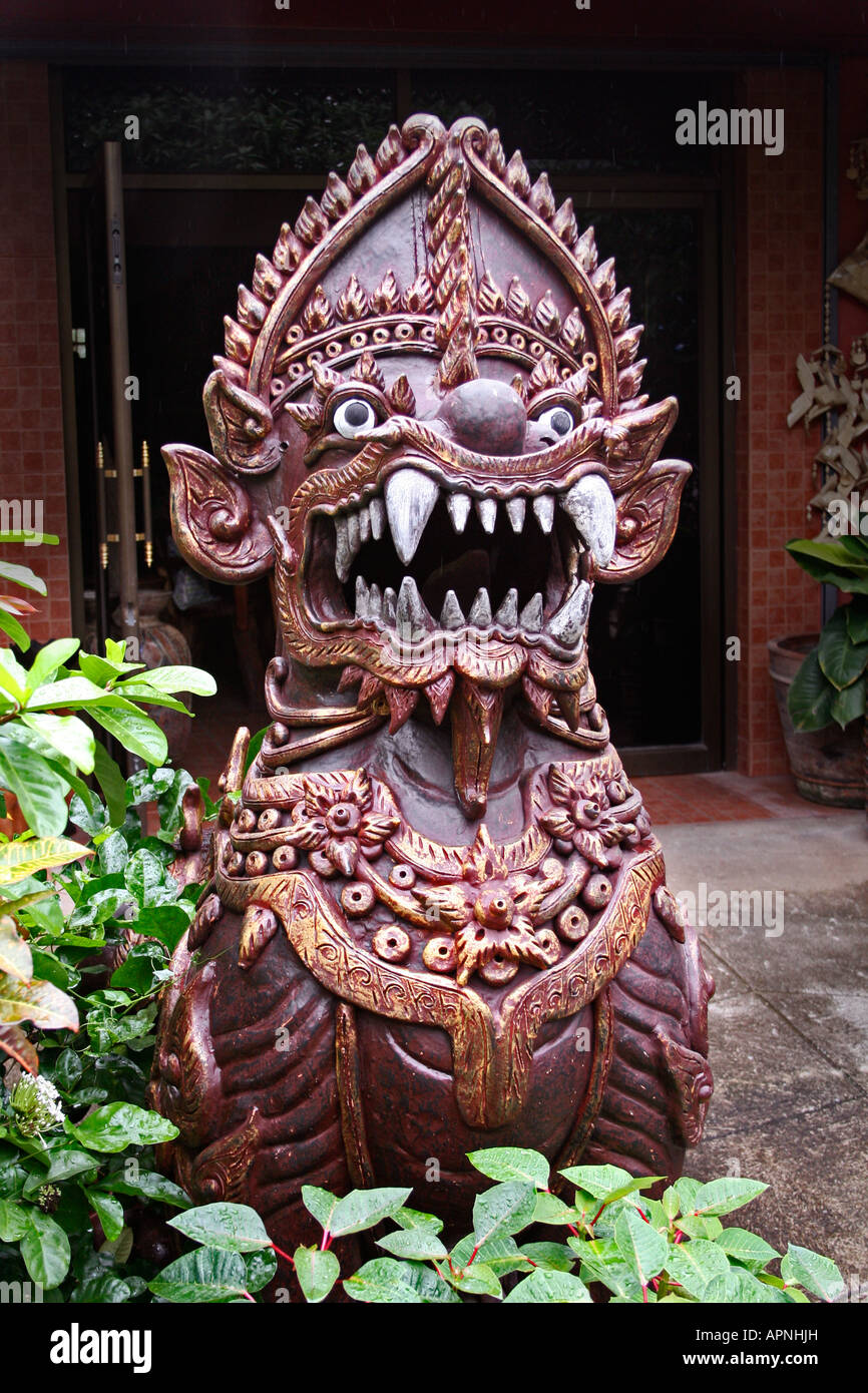 Wooden carved Thai demon at a doorway entrance, Thailand Stock Photo ...