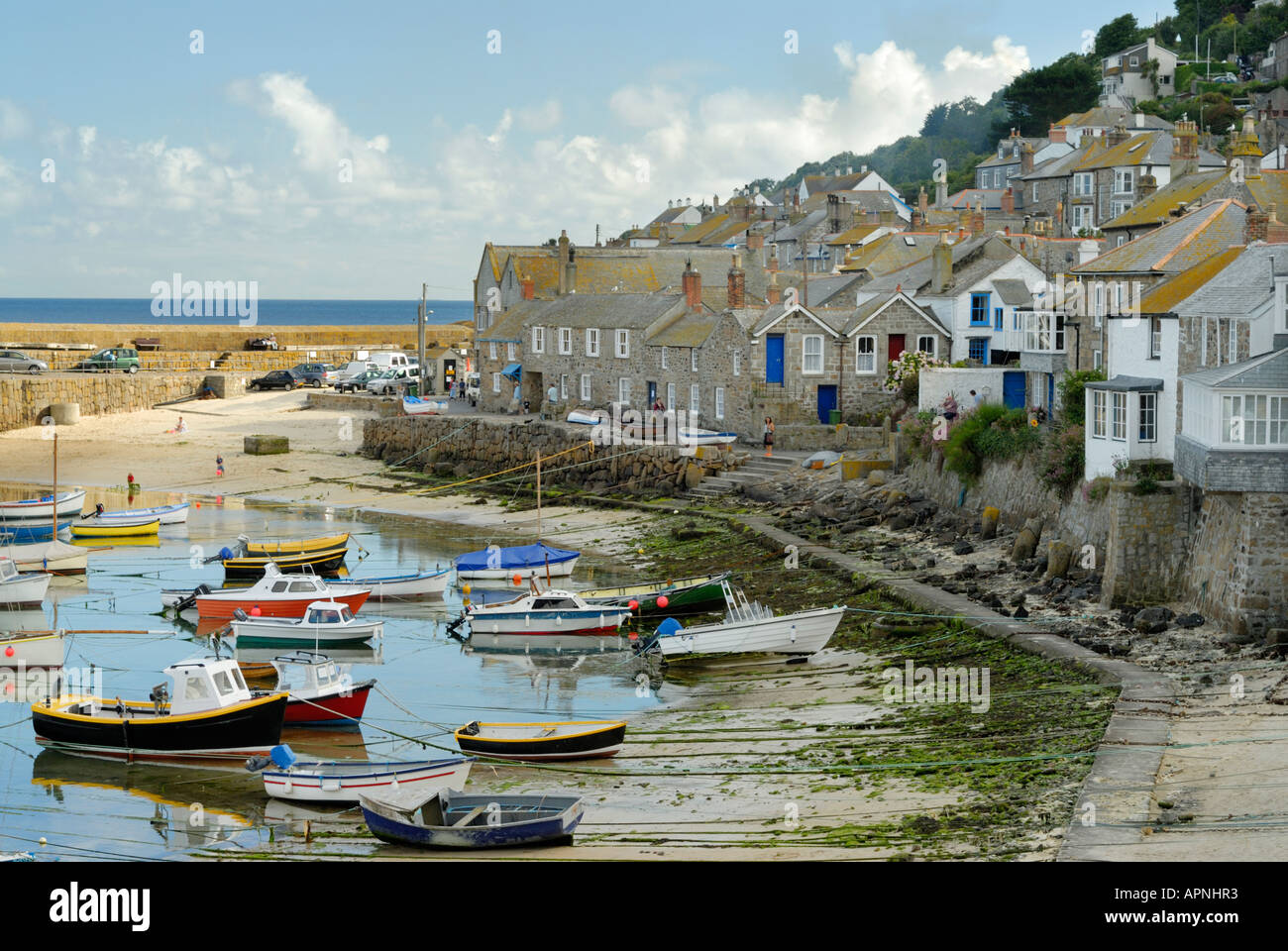 Mousehole harbour Cornwall at low tide. Mousehole village and Houses ...