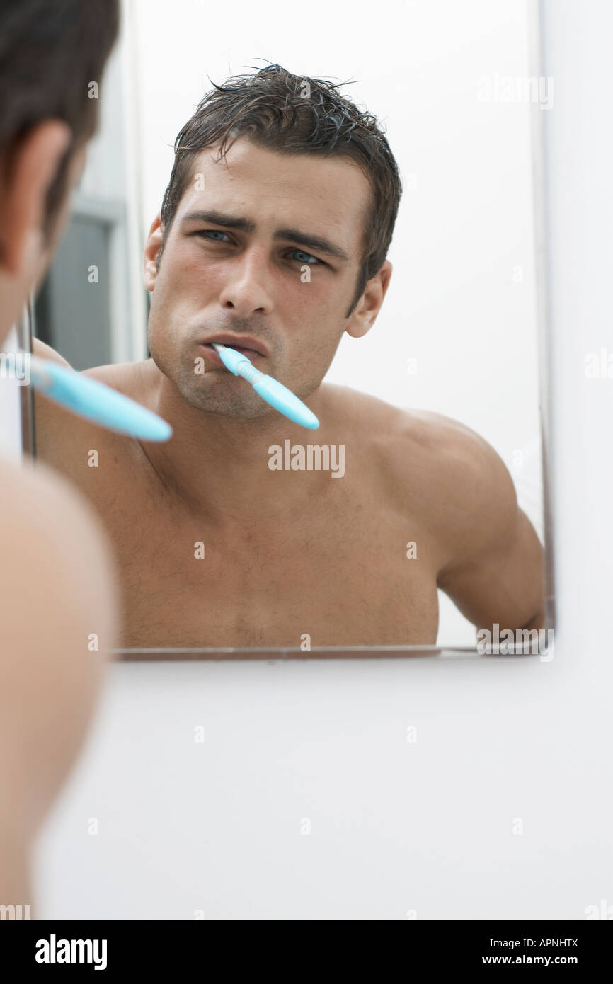 Mid adult man cleaning teeth Stock Photo - Alamy