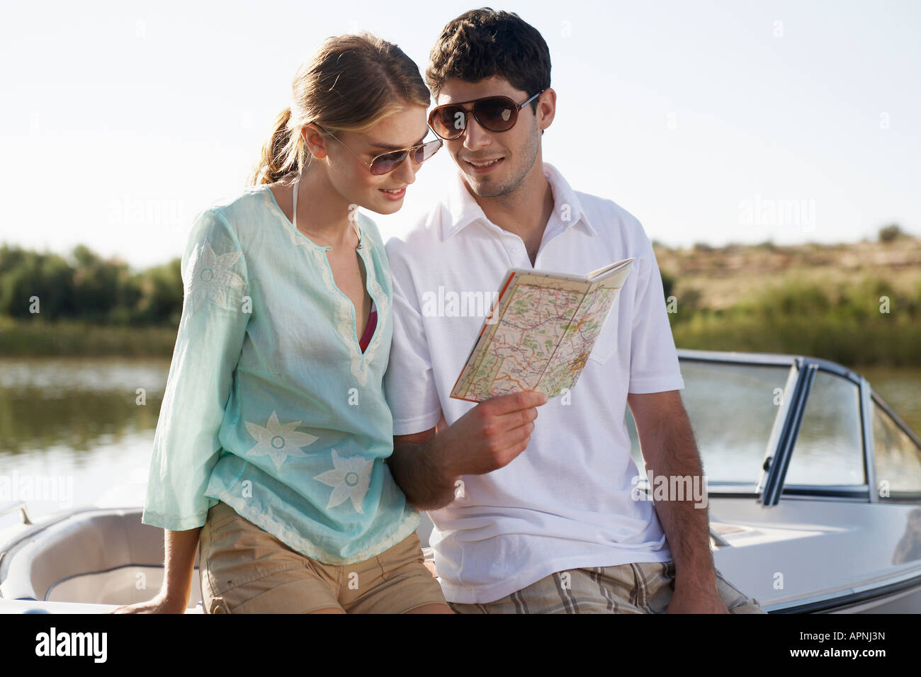 Young couple looking at map Stock Photo - Alamy
