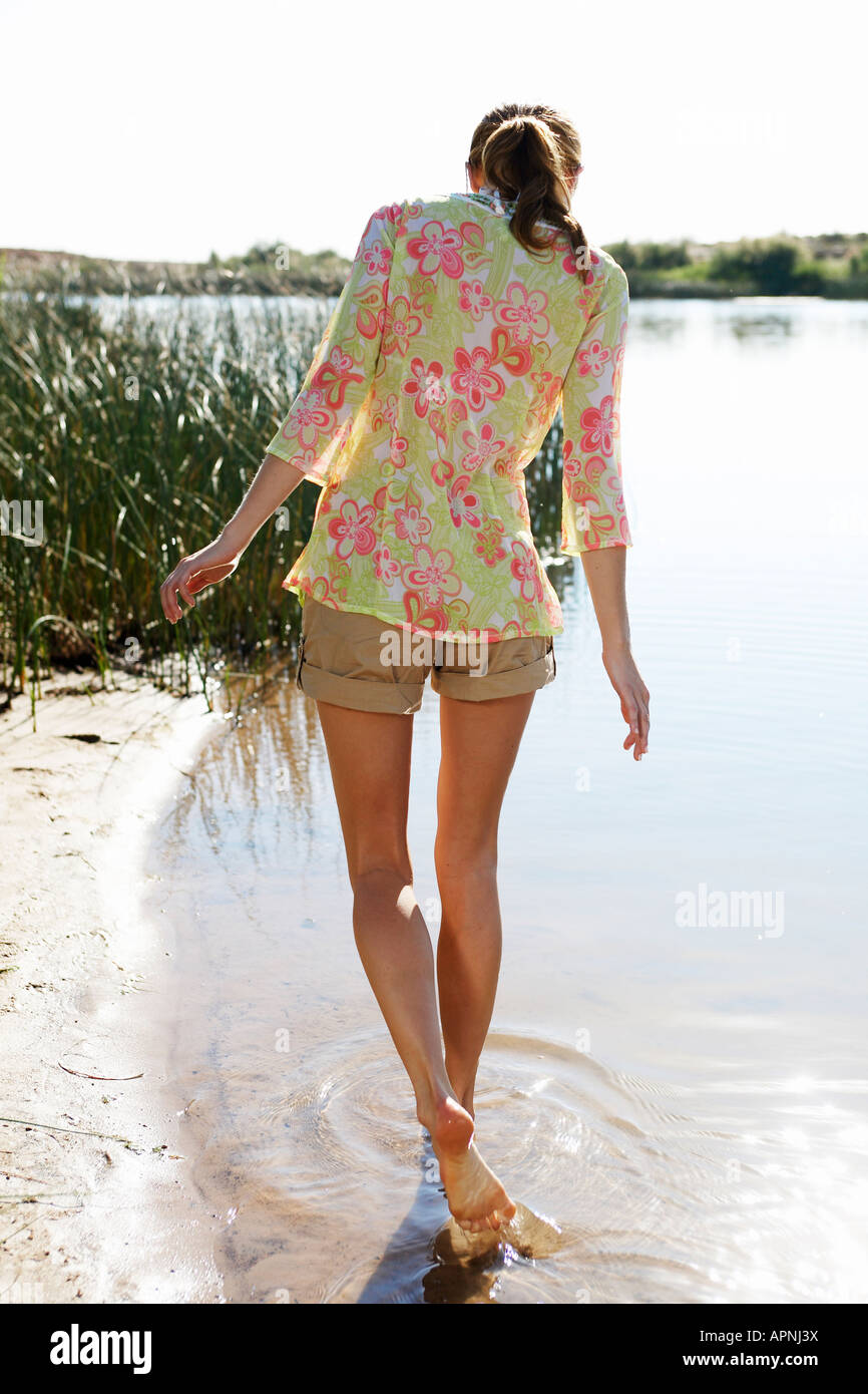 Young woman walking in lake Stock Photo - Alamy