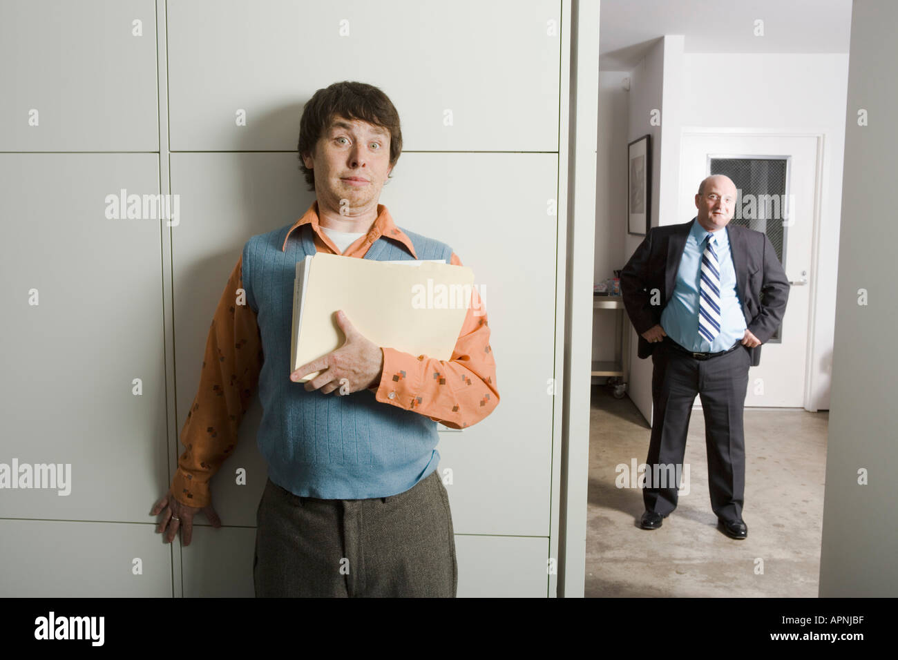 Employee hiding from the boss Stock Photo - Alamy