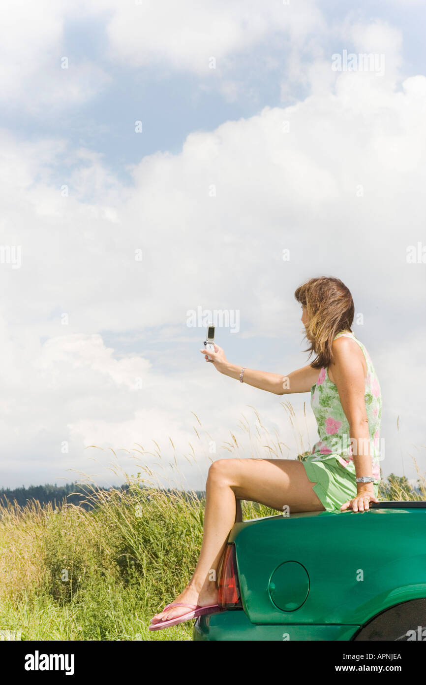 Woman taking photo with mobile phone Stock Photo - Alamy