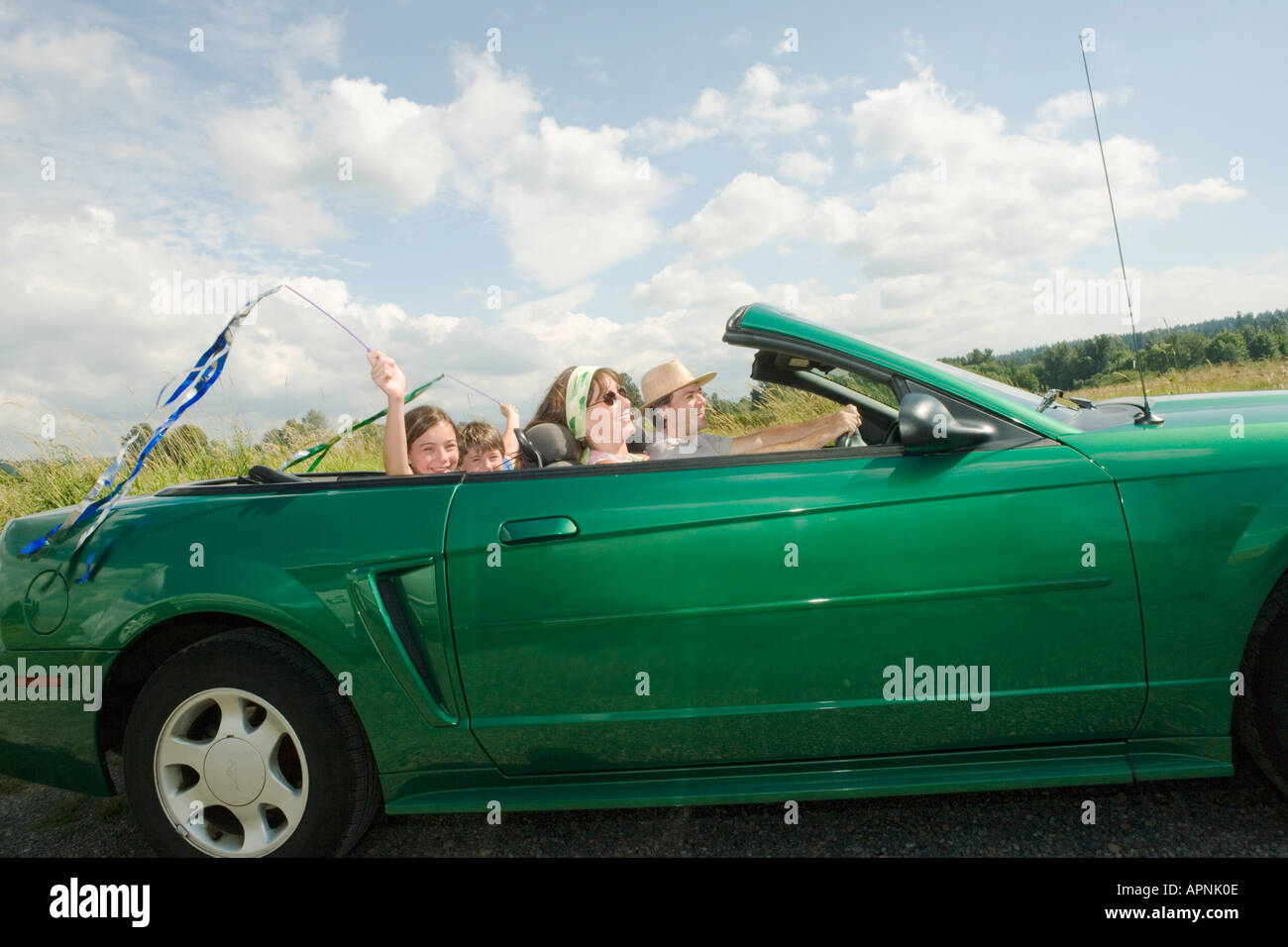 Family riding in convertible car Stock Photo - Alamy