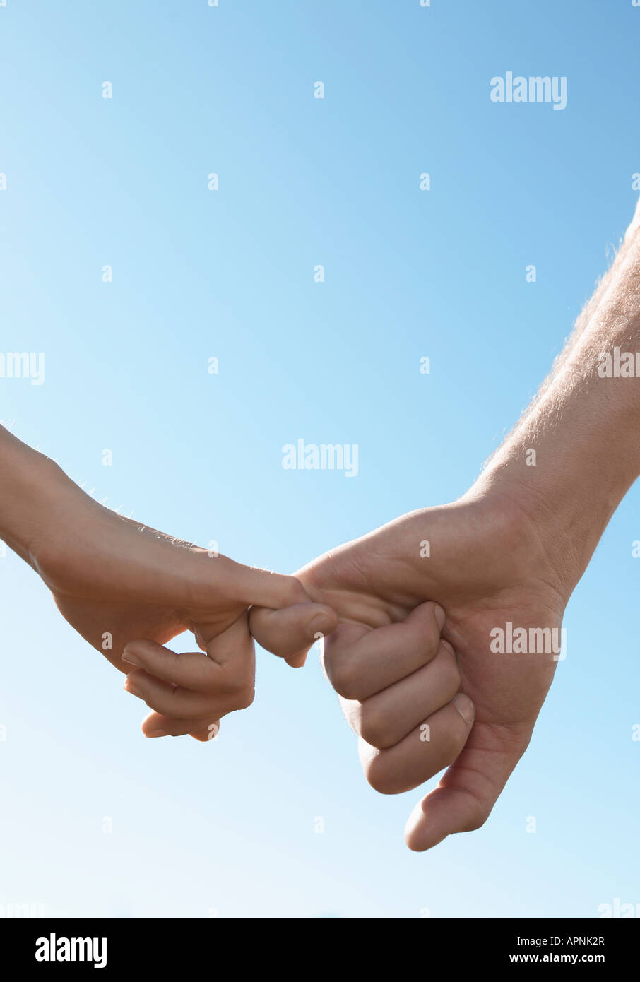 Young couple linking little fingers (focus on hands Stock Photo - Alamy