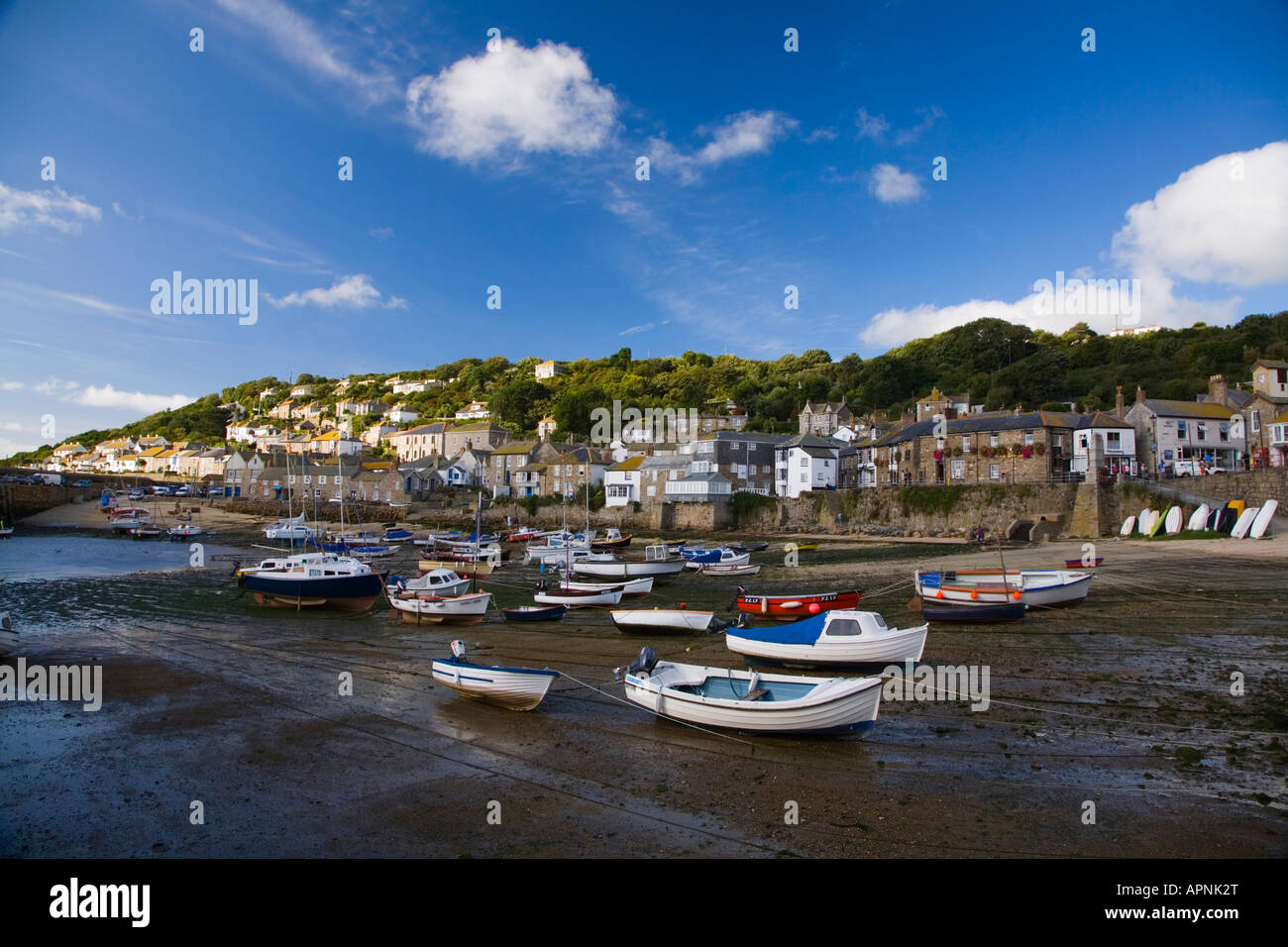 Mousehole Harbour at low tide showing boats and cottages, West Cornwall ...