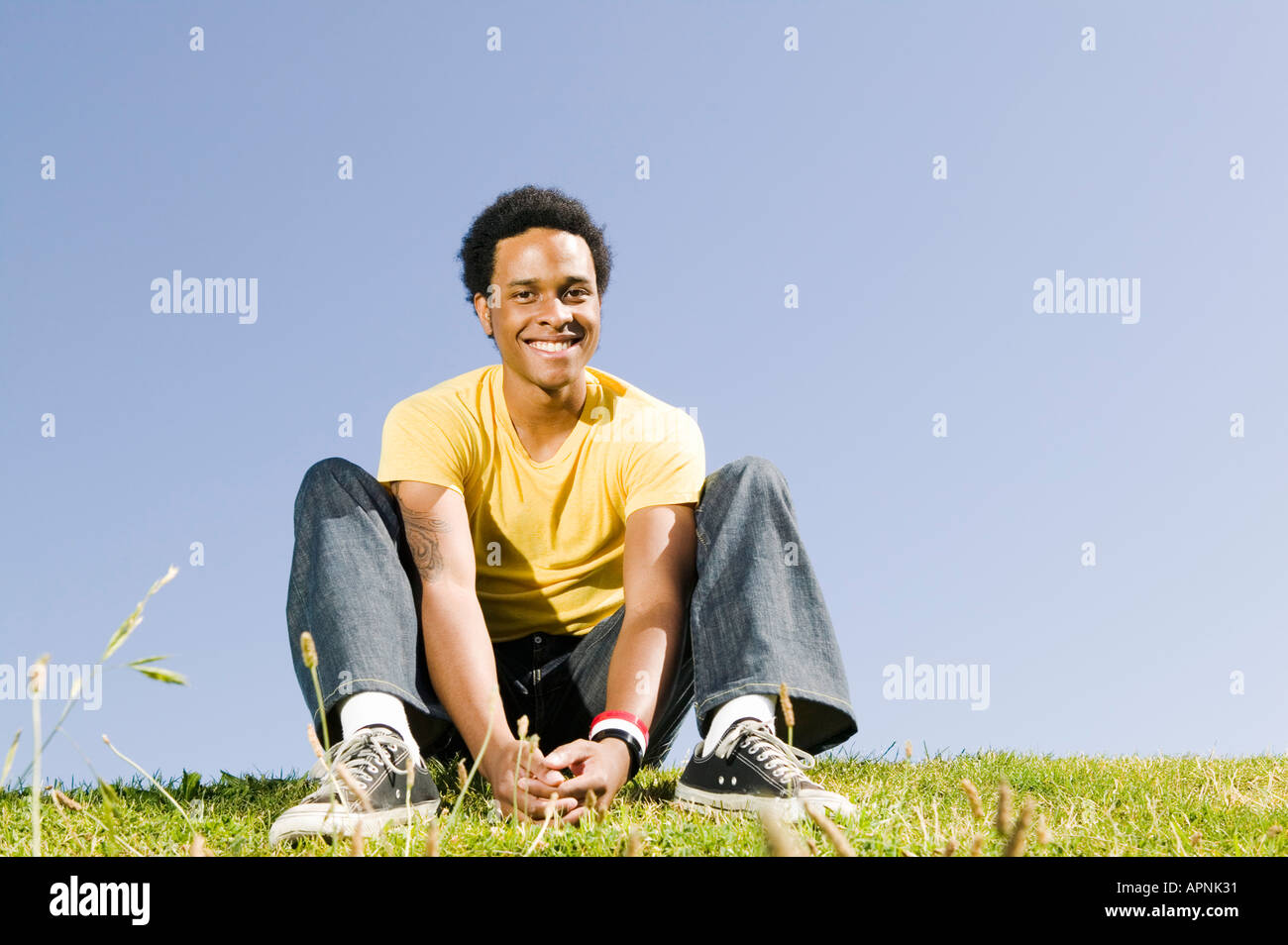 Man smiles looking camera sitting hi-res stock photography and images ...