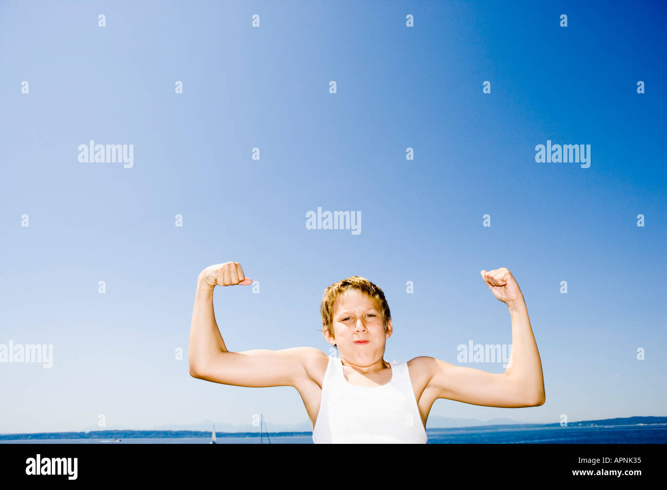 Young boy flexing his muscles Stock Photo - Alamy