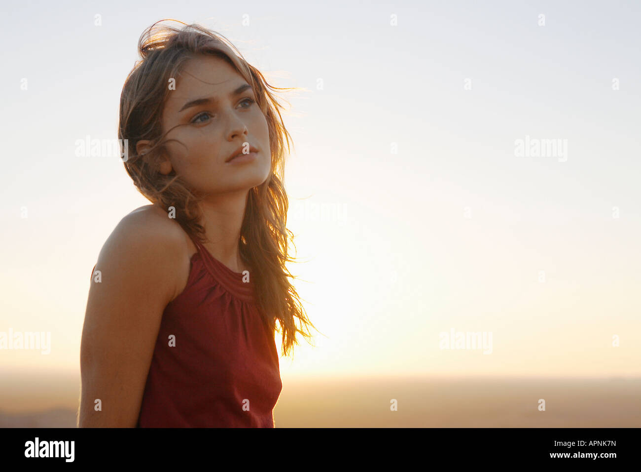 Young woman at sunset Stock Photo - Alamy