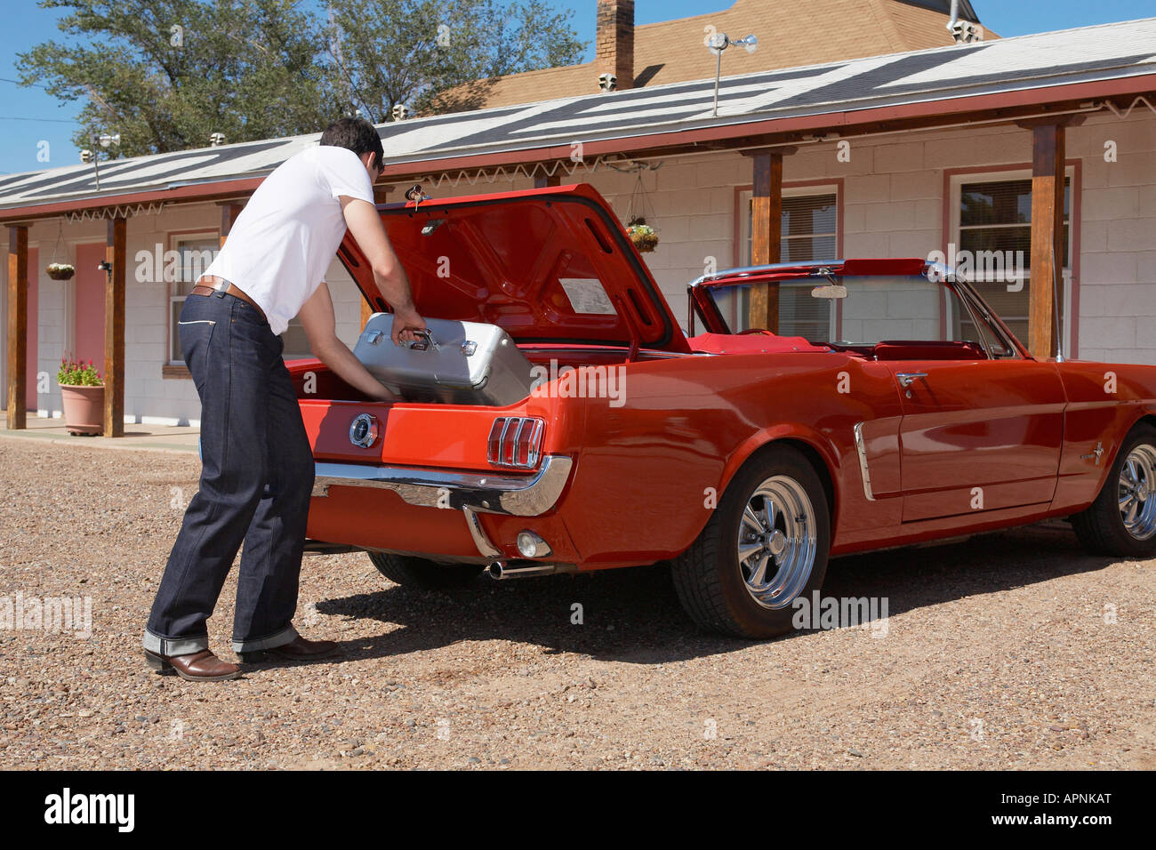 Young man taking briefcase from car Stock Photo - Alamy