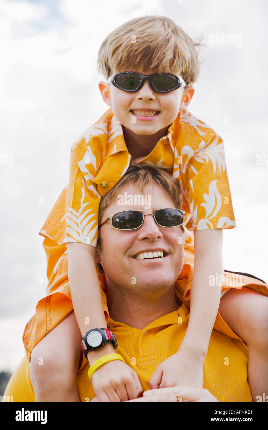 Kid son riding dads shoulders hi-res stock photography and images - Alamy