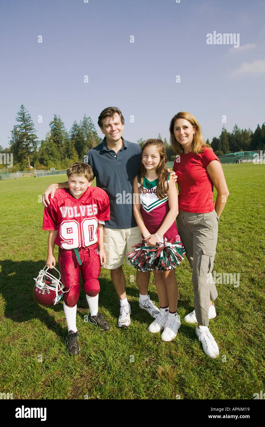Football player and cheerleader with parents Stock Photo - Alamy