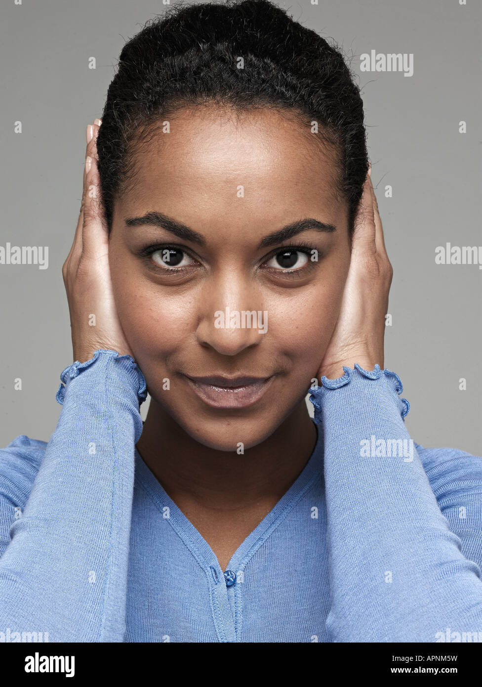 Young woman covering ears with hands Stock Photo - Alamy