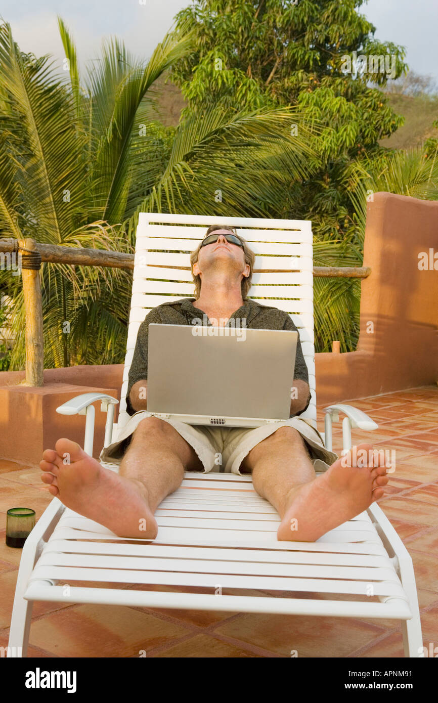 Sunbathing man with laptop outside Stock Photo - Alamy