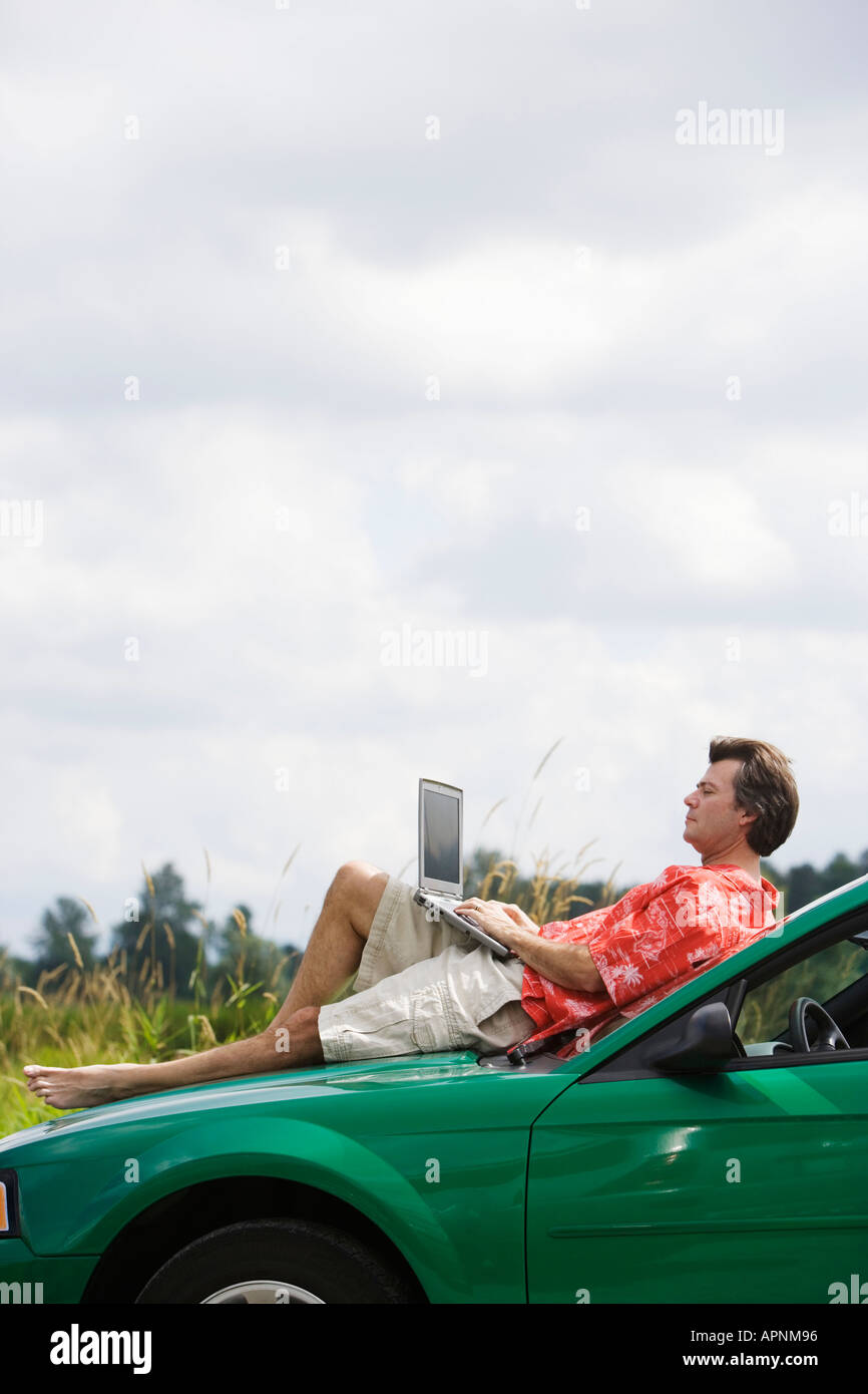 Man lying on hood of car hi-res stock photography and images - Alamy