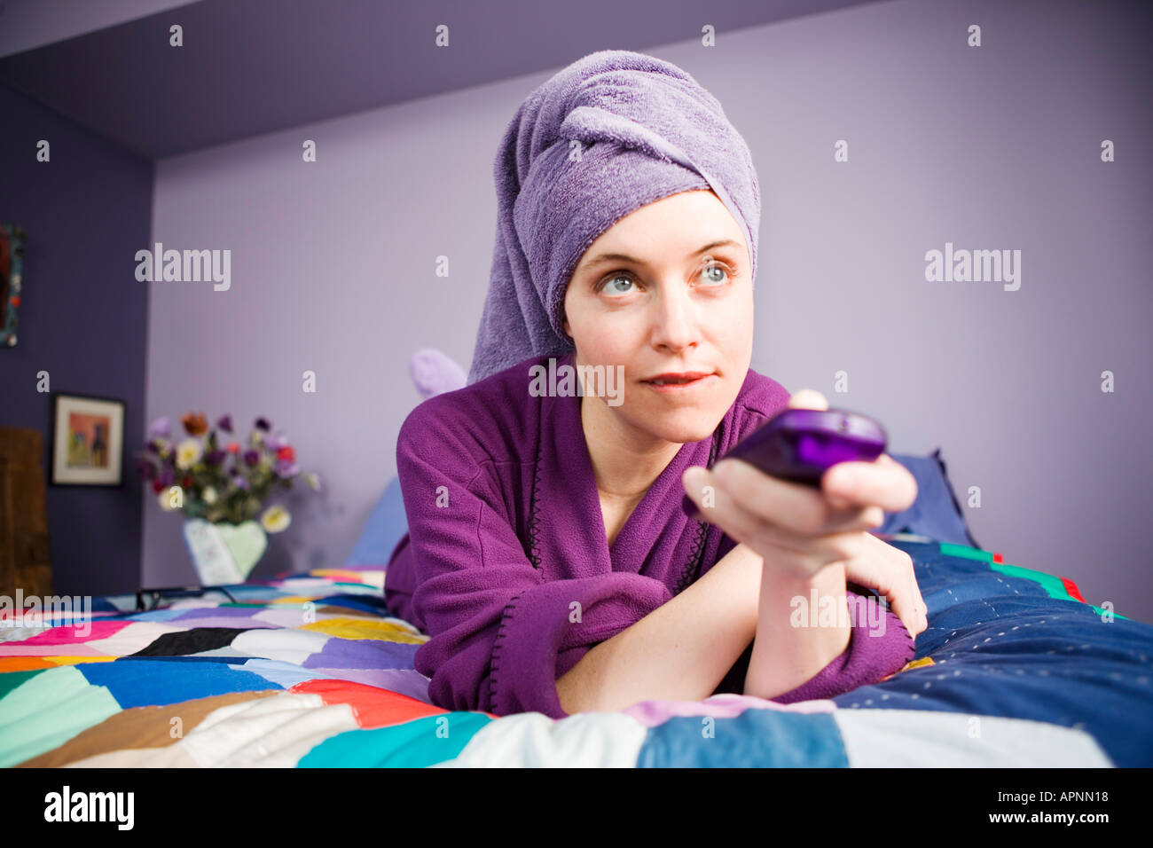 Woman holding remote control Stock Photo - Alamy