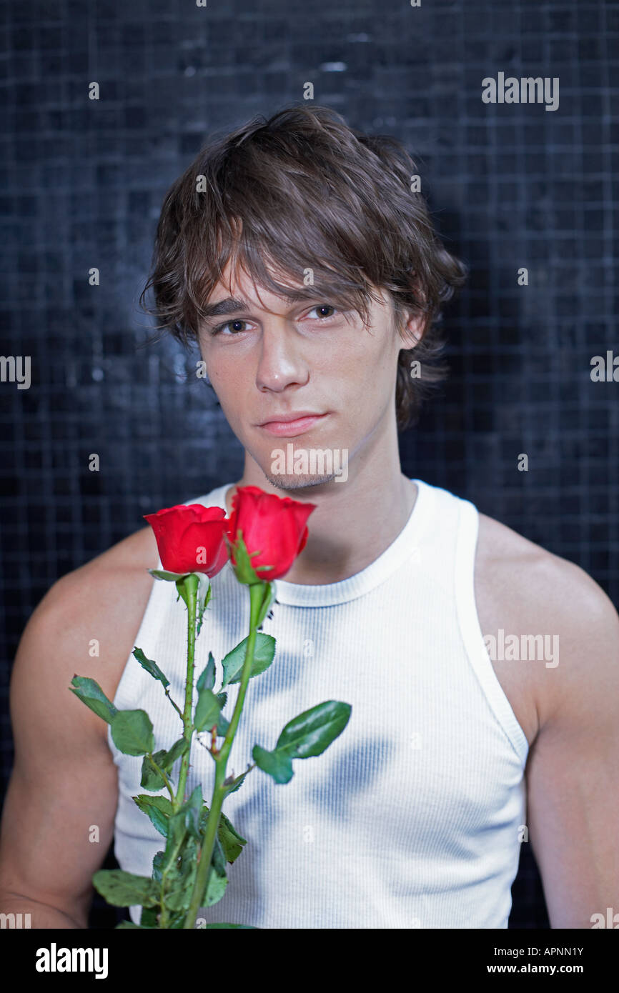 Young Man with Two Red Roses Stock Photo - Alamy