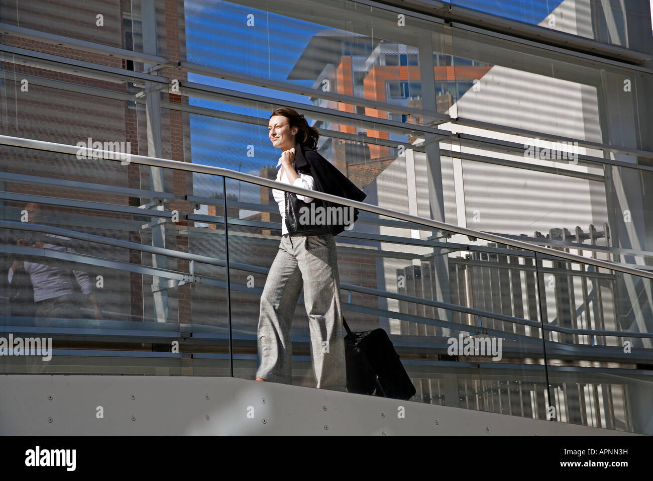 Businessman Pulling Suitcase on Ramp Stock Photo - Alamy