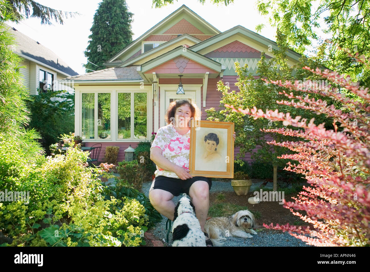 Woman holding portrait of herself as a girl Stock Photo - Alamy