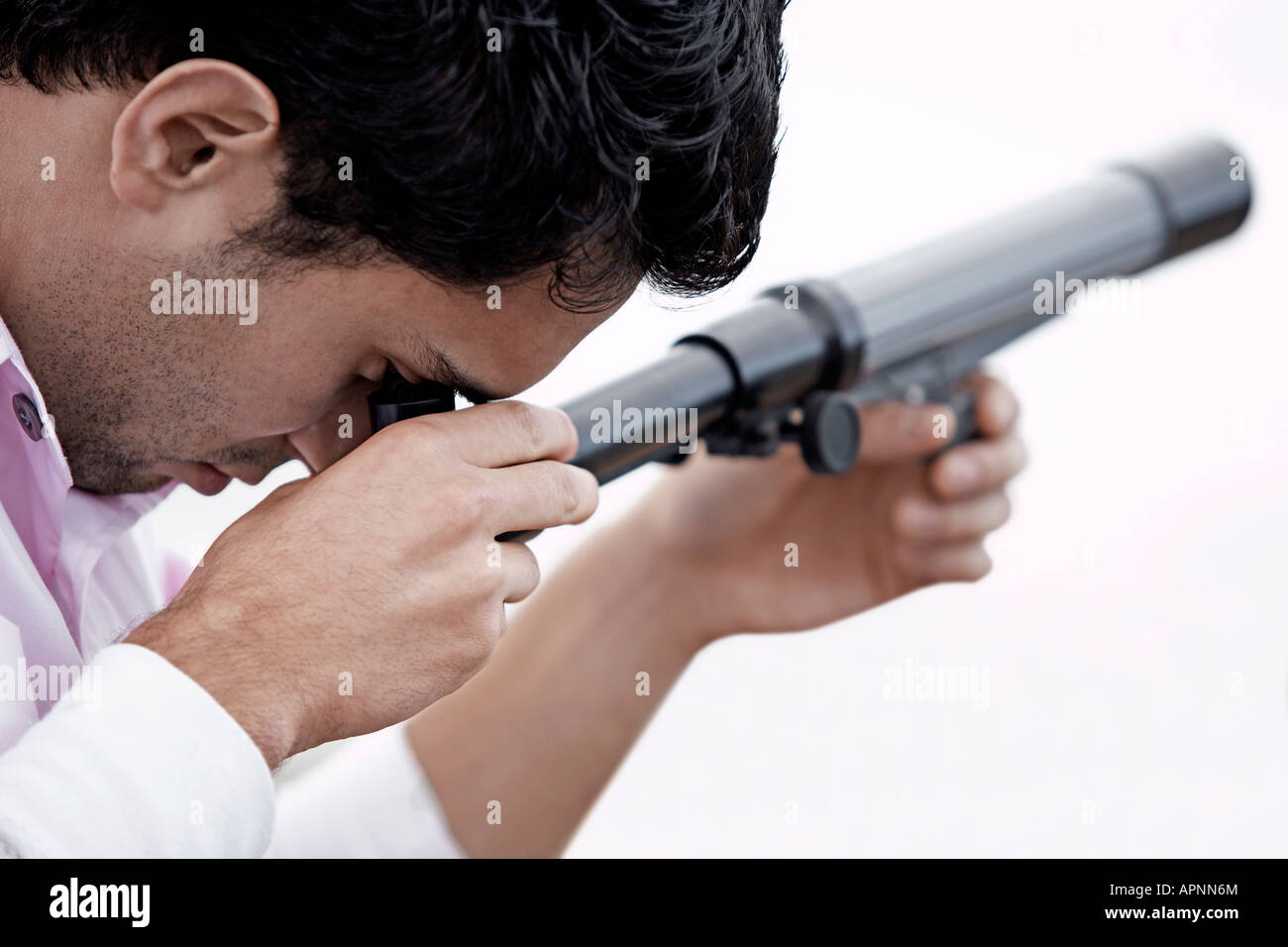 Young Man Using Telescope Stock Photo - Alamy