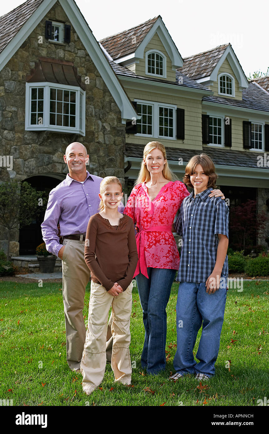 Family with Two Children Near House Stock Photo - Alamy