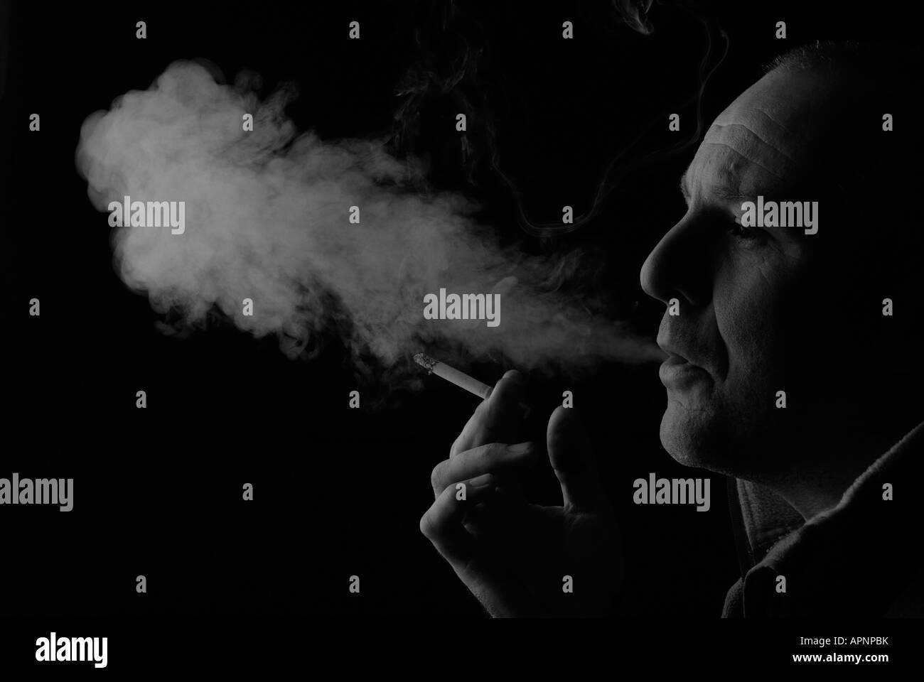 Man smoking a cigarette Stock Photo - Alamy