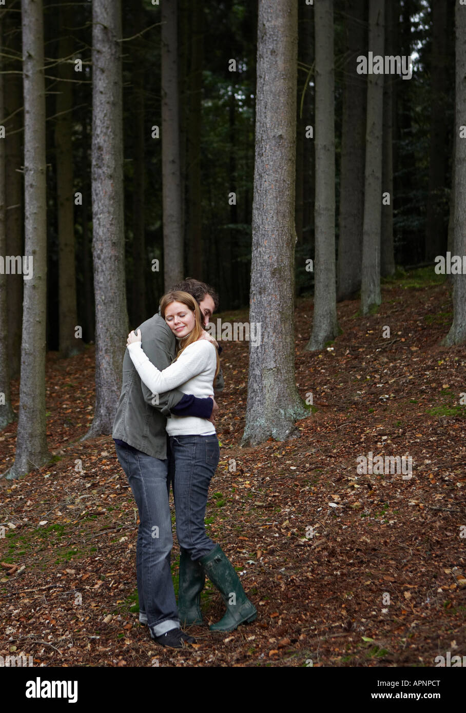 Couple Hugging in Forest Stock Photo - Alamy