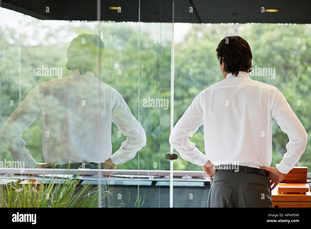 Mid Adult Man Looking Through Window Stock Photo - Alamy