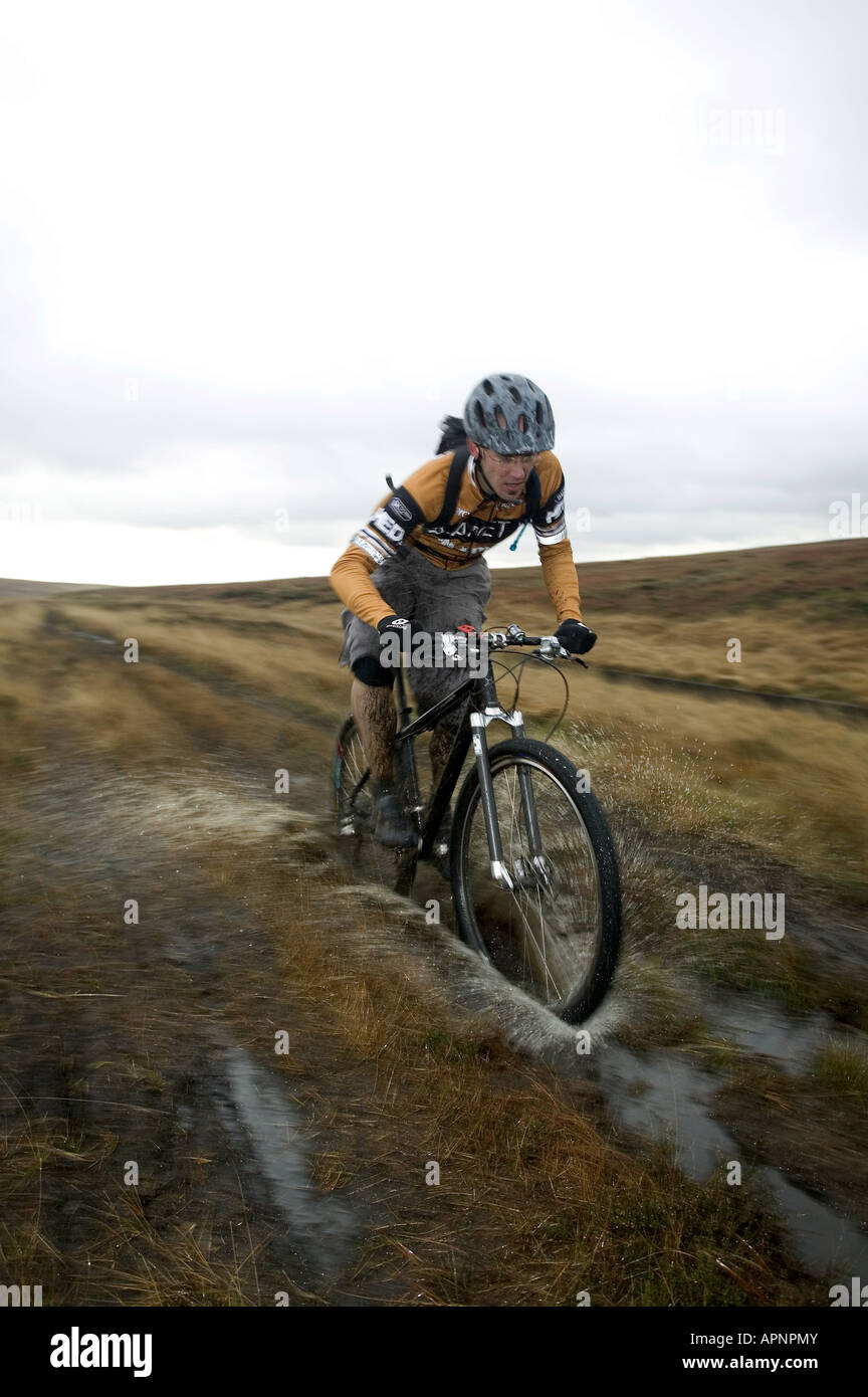 Riding a bike through a puddle hi-res stock photography and images - Alamy