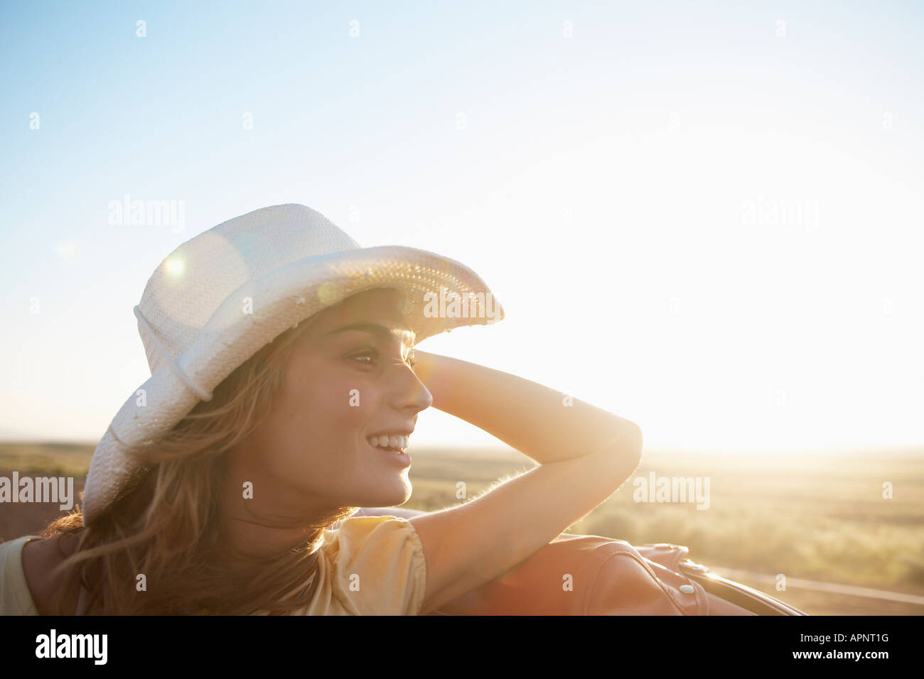 Young woman in cowboy hat traveling in convertible Stock Photo - Alamy