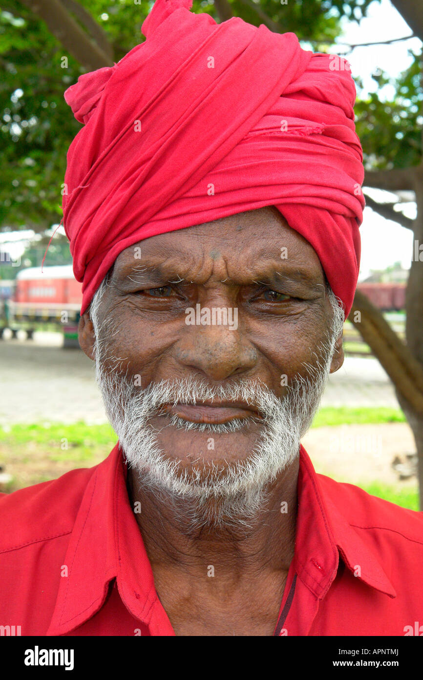 portrait of indian railways worker on station platform near trichy ...