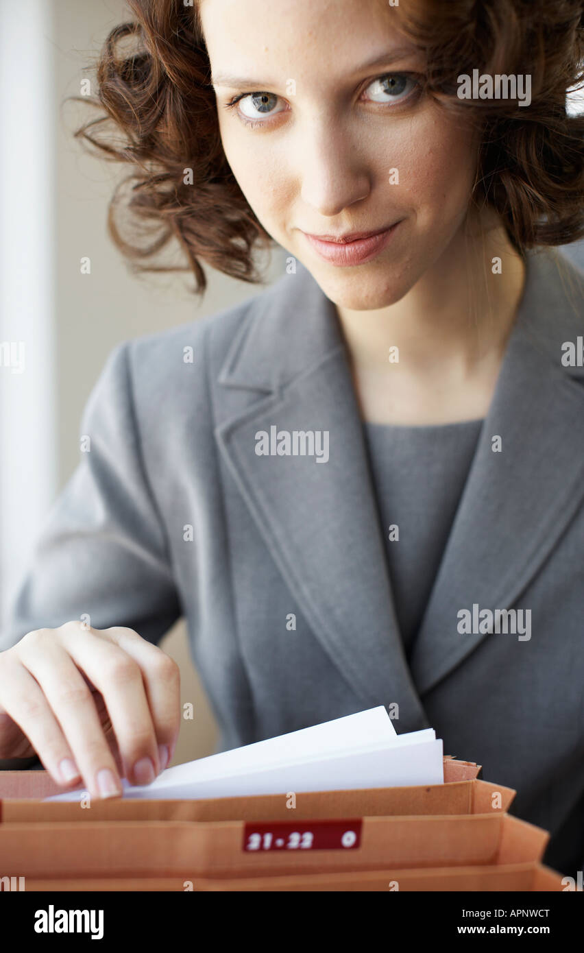 Businesswoman going through files Stock Photo - Alamy