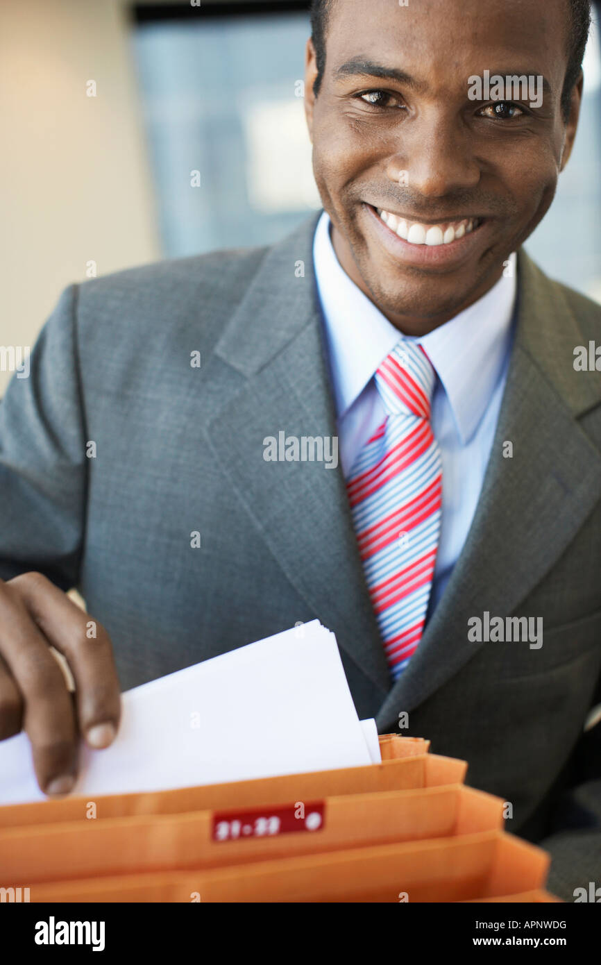 Businessman going through files Stock Photo - Alamy