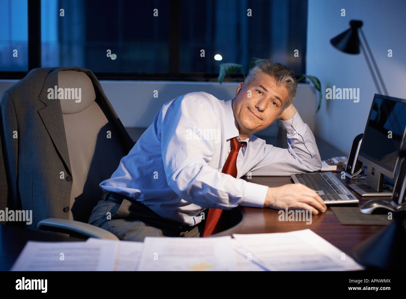 Male office worker working late Stock Photo - Alamy