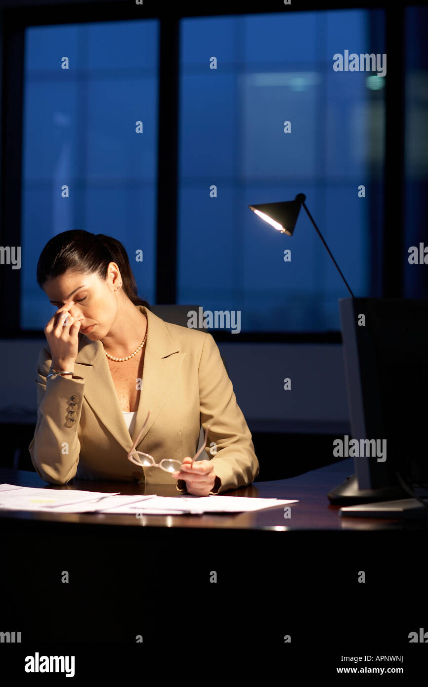 Female office worker working late Stock Photo - Alamy