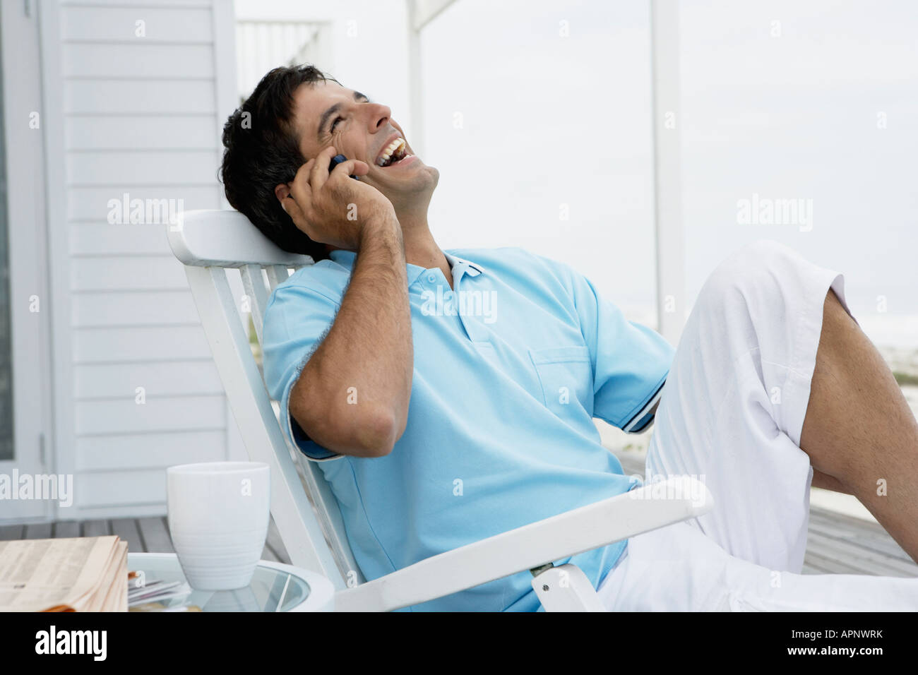 Happy man using mobile phone near beach Stock Photo - Alamy