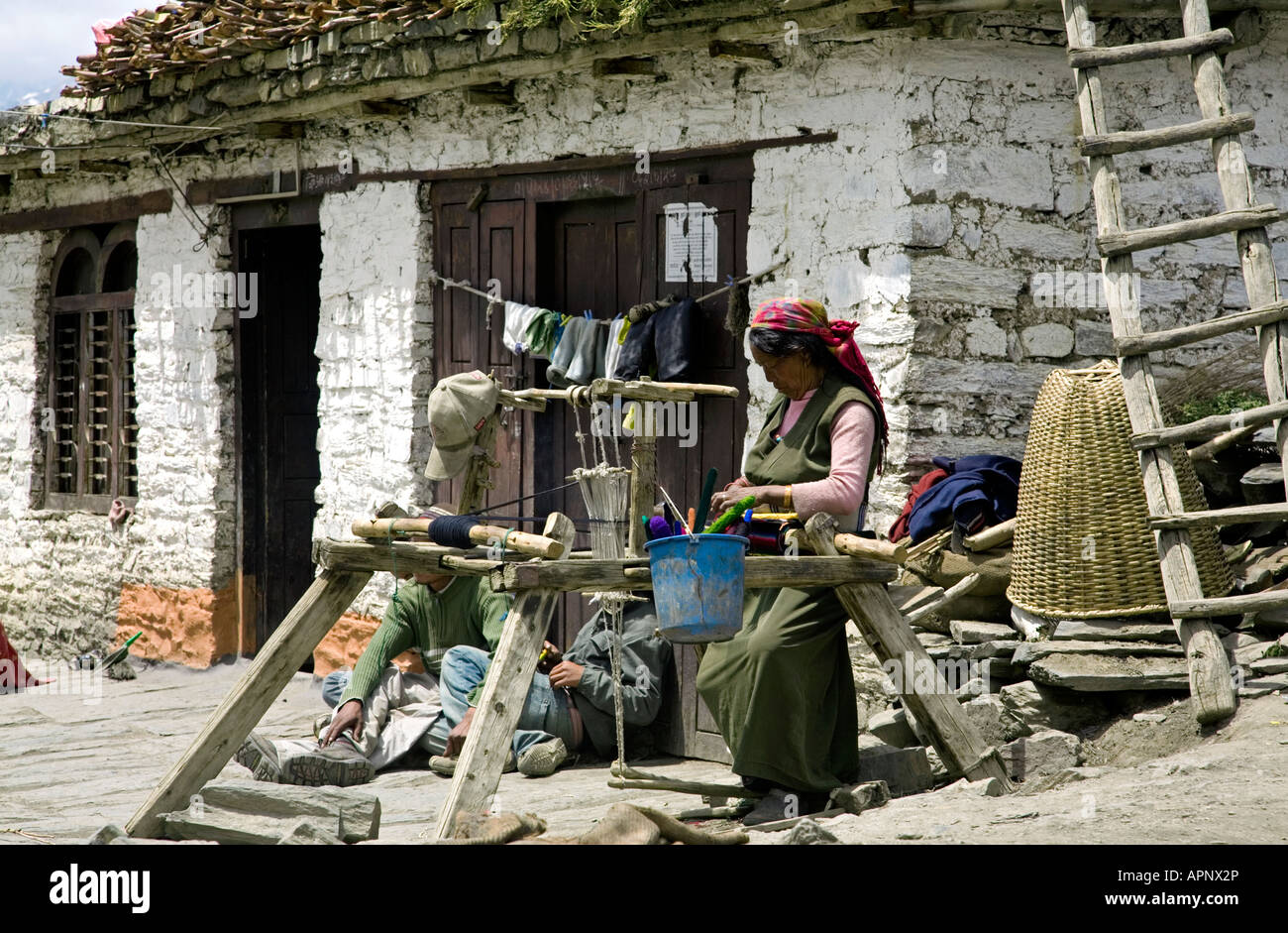 Woman weaving yak wool shawls. Ranipauwa village. Annapurna circuit ...
