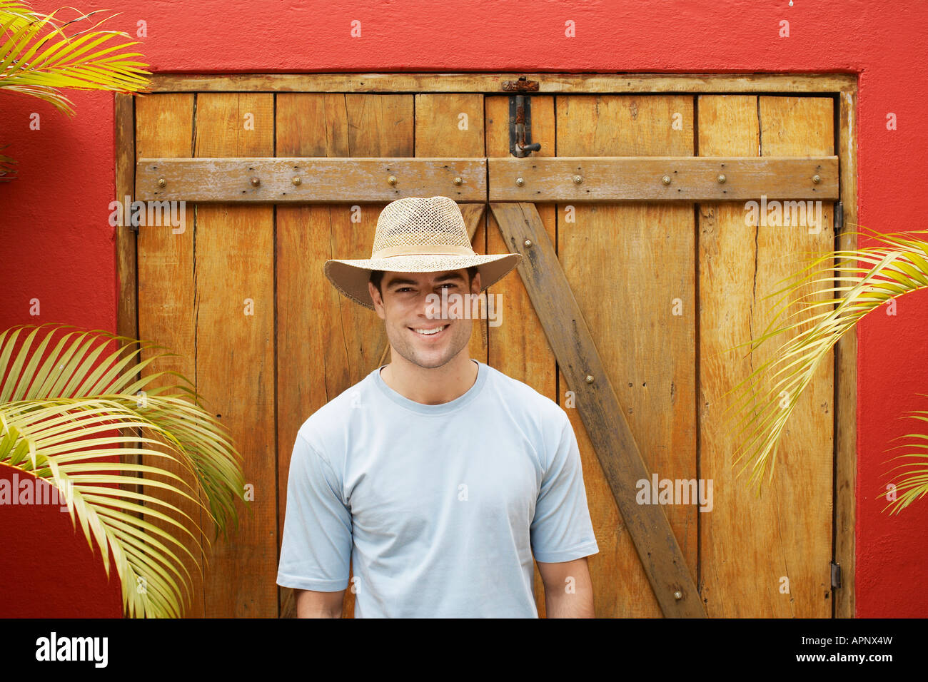 Young man by wooden window shutters Stock Photo - Alamy