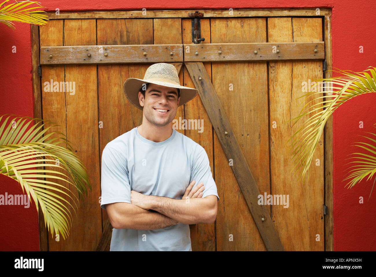 Young man by wooden window shutters Stock Photo - Alamy