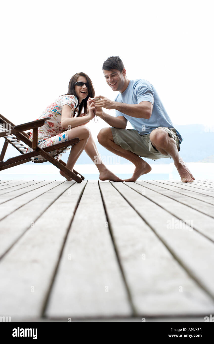 Young man showing digital camera to his girlfriend Stock Photo - Alamy