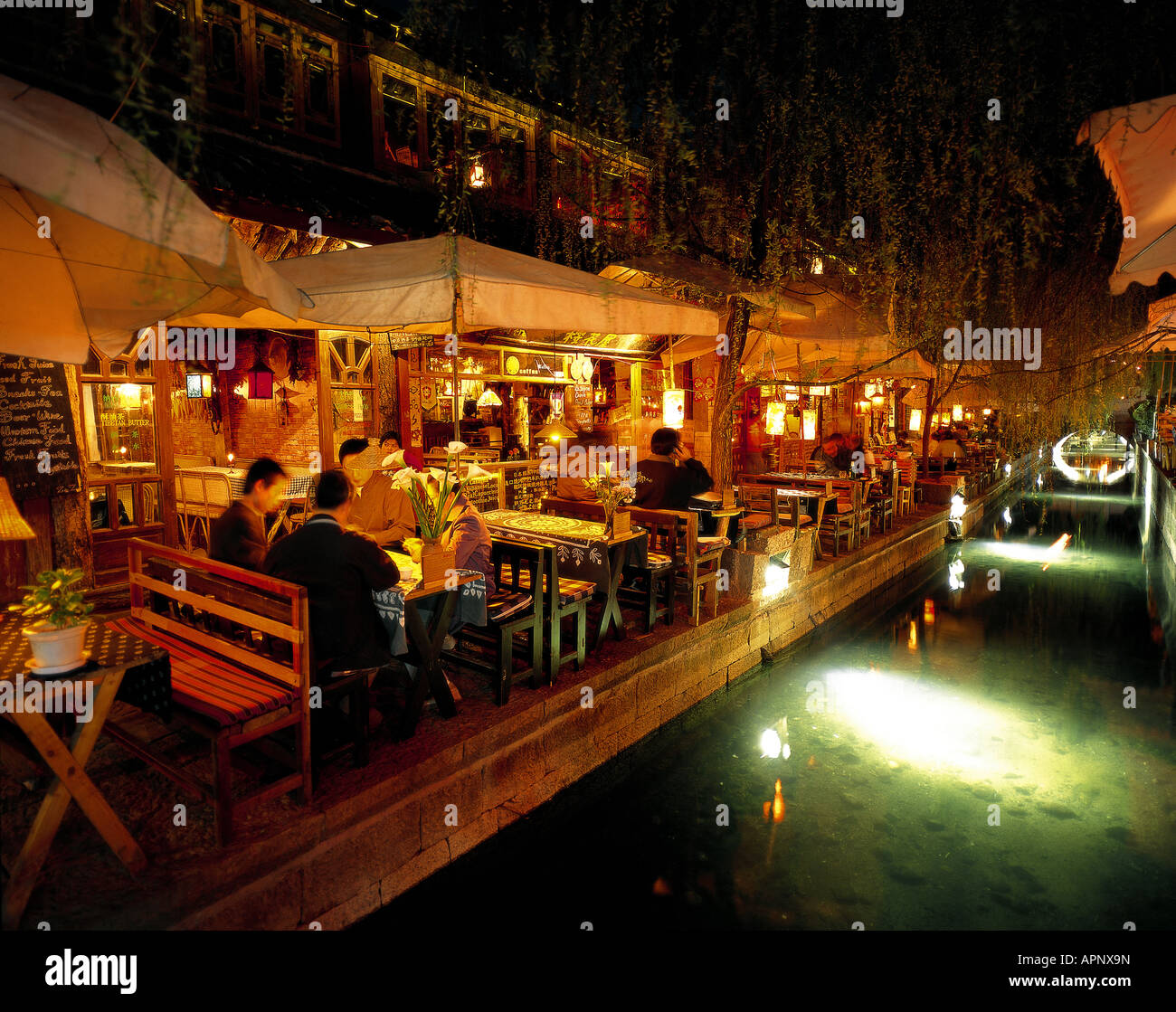 Riverside restaurants and cafes at night in Lijiang, China Stock Photo ...
