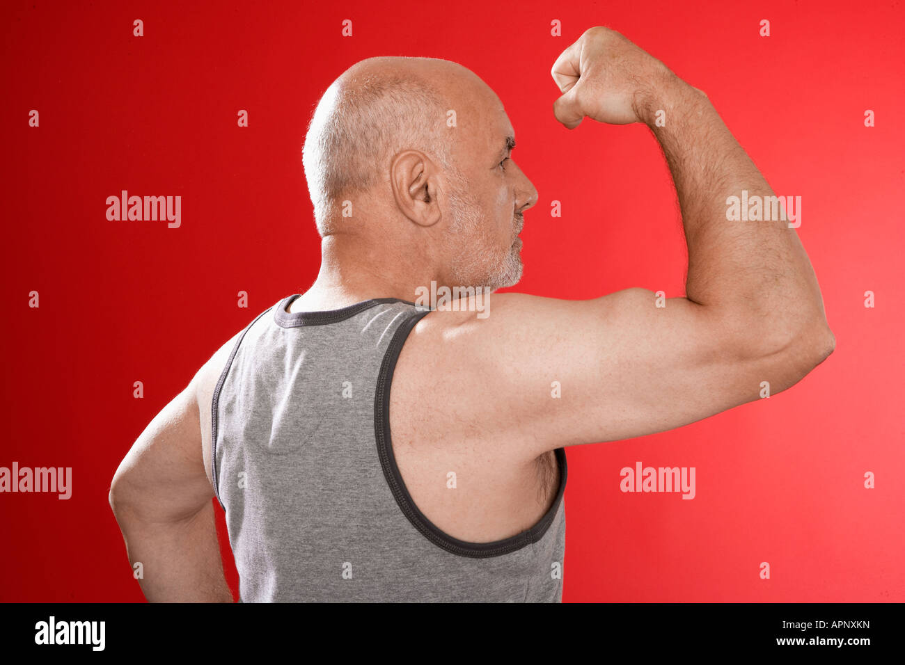 Senior man flexing muscles Stock Photo - Alamy