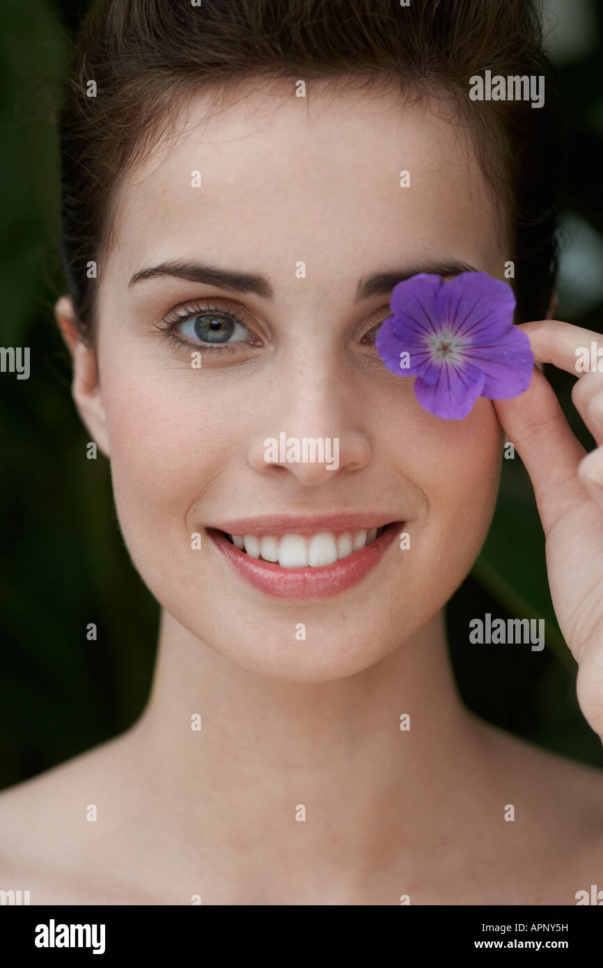 Woman covering an eye with flower hi-res stock photography and images ...